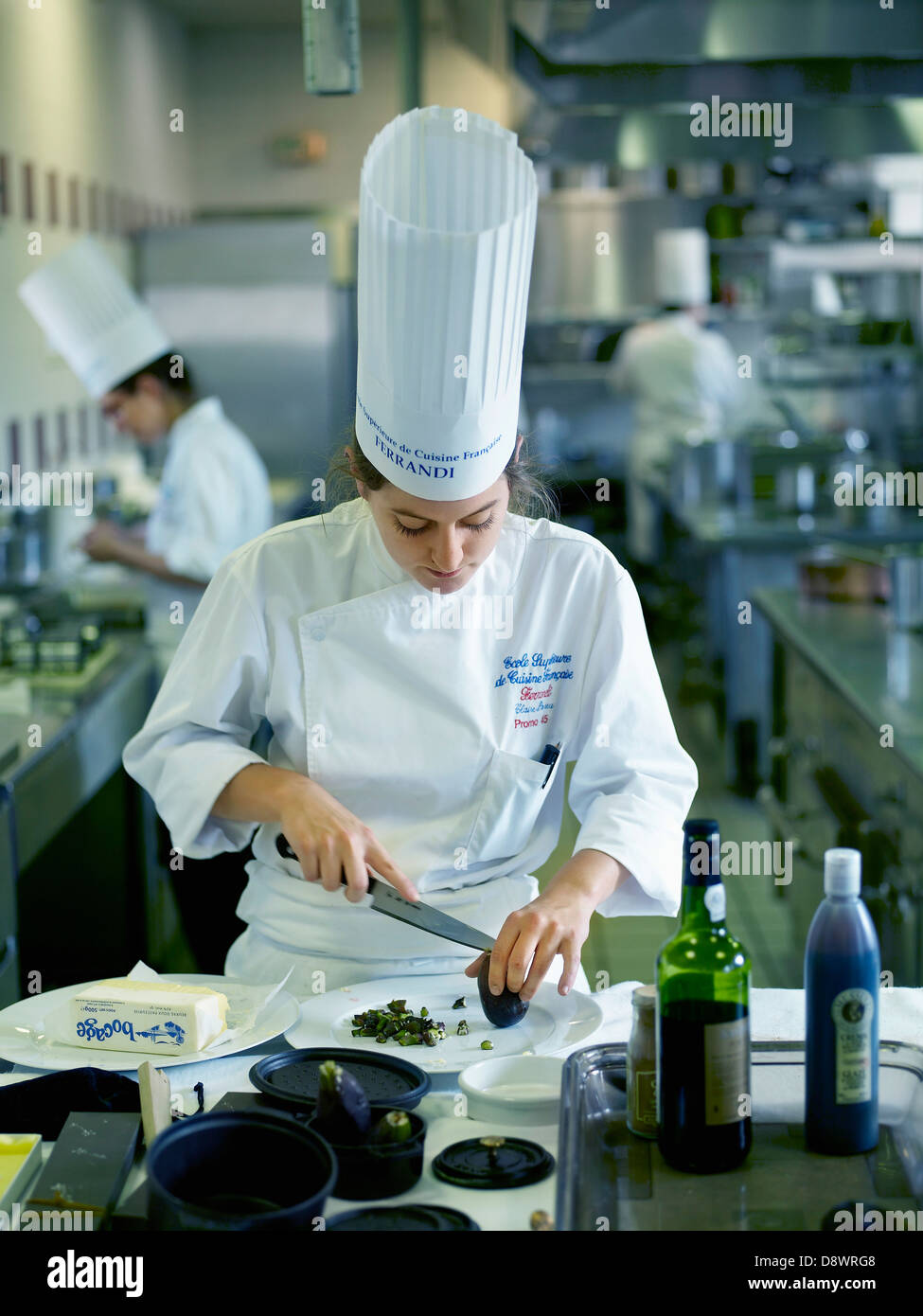 Cooking student preparing figs Stock Photo - Alamy