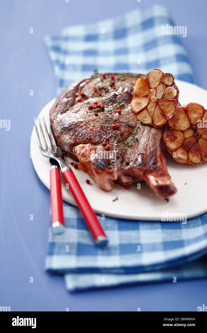 Grilled beef chop with pink peppercorns,thyme and confit garlic Stock ...