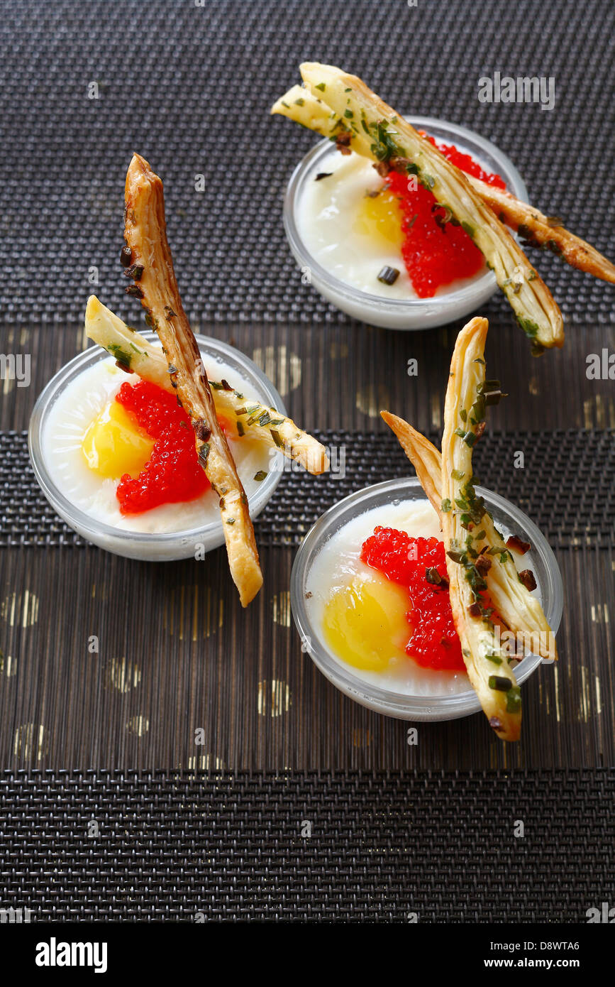 Coodled eggs with fish roe and herb flaky pastry sticks Stock Photo - Alamy