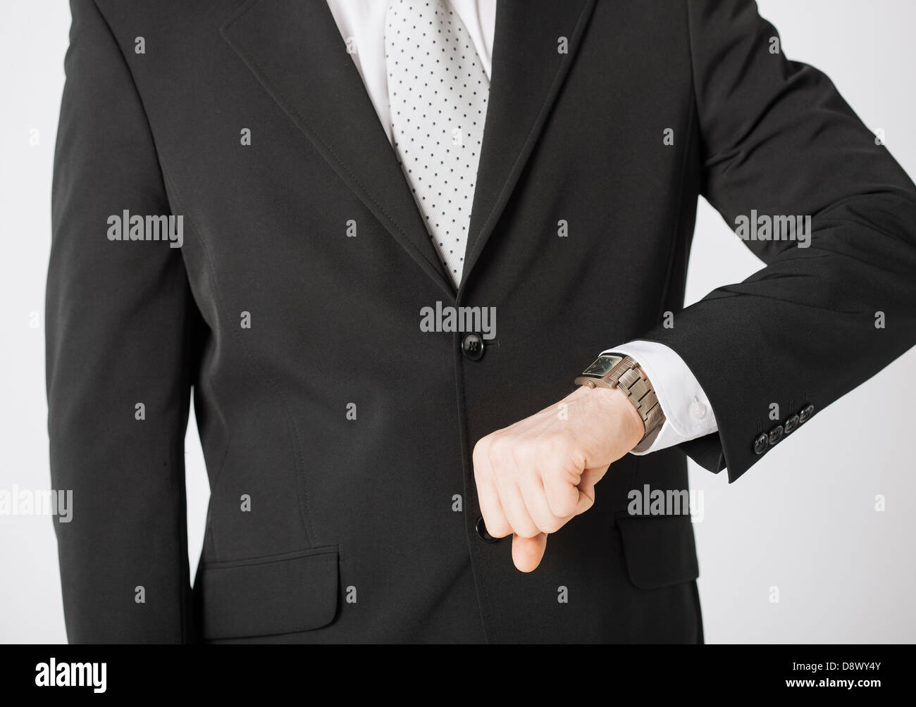 man looking at wristwatch Stock Photo - Alamy