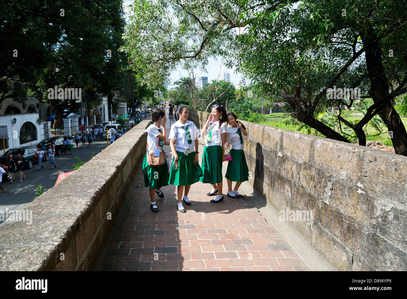 Girls walking on the City Wall of Intramouros, the old Town of Manila ...