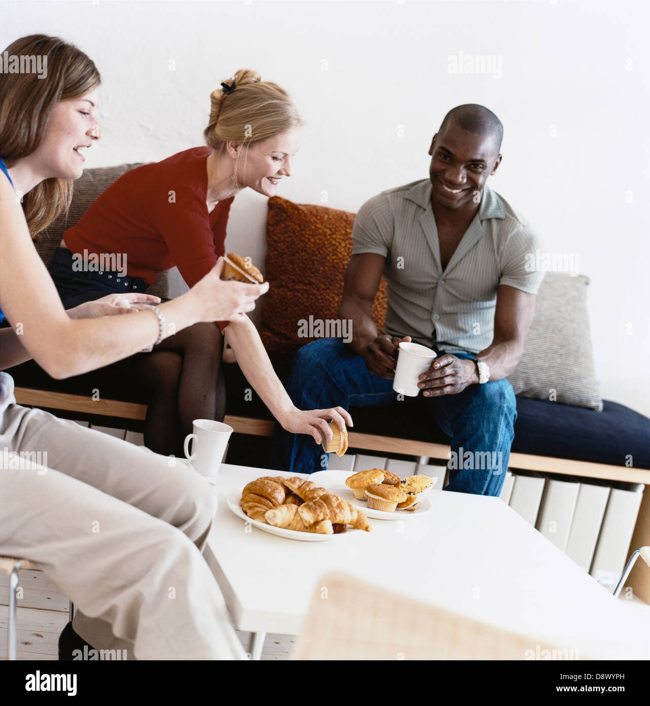 Three friends taking a coffee-break together Stock Photo - Alamy