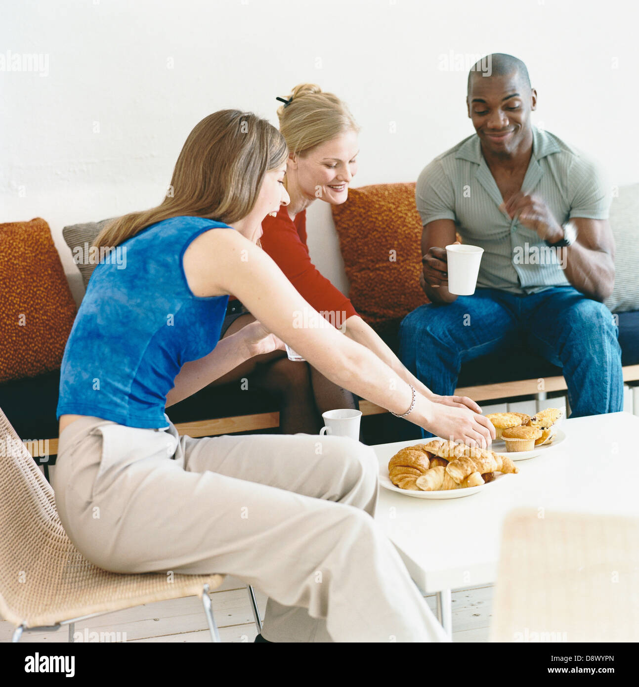 Three friends taking a coffee-break together Stock Photo - Alamy