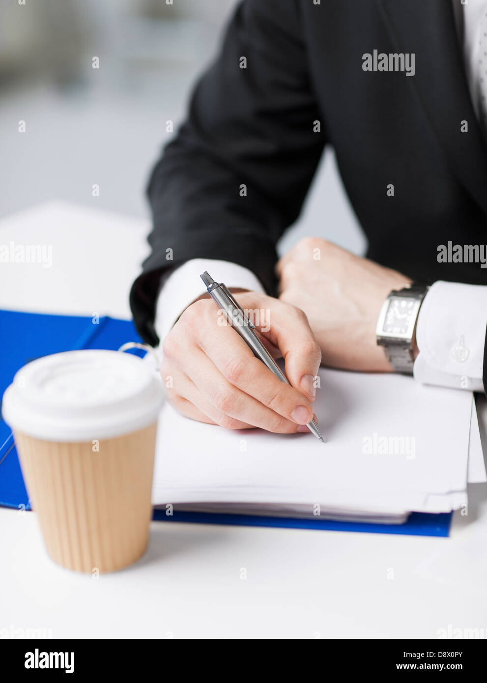 businessman with coffee writing something Stock Photo - Alamy