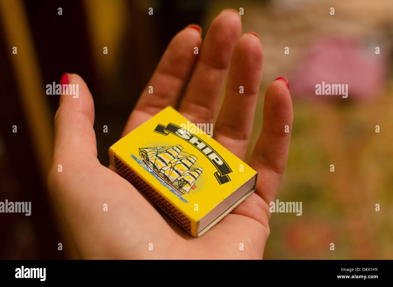 A woman's hand holding a box of matches Stock Photo - Alamy