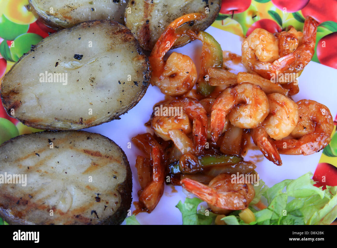 prawn in sweet red sauce with a potato and vegetables Stock Photo - Alamy