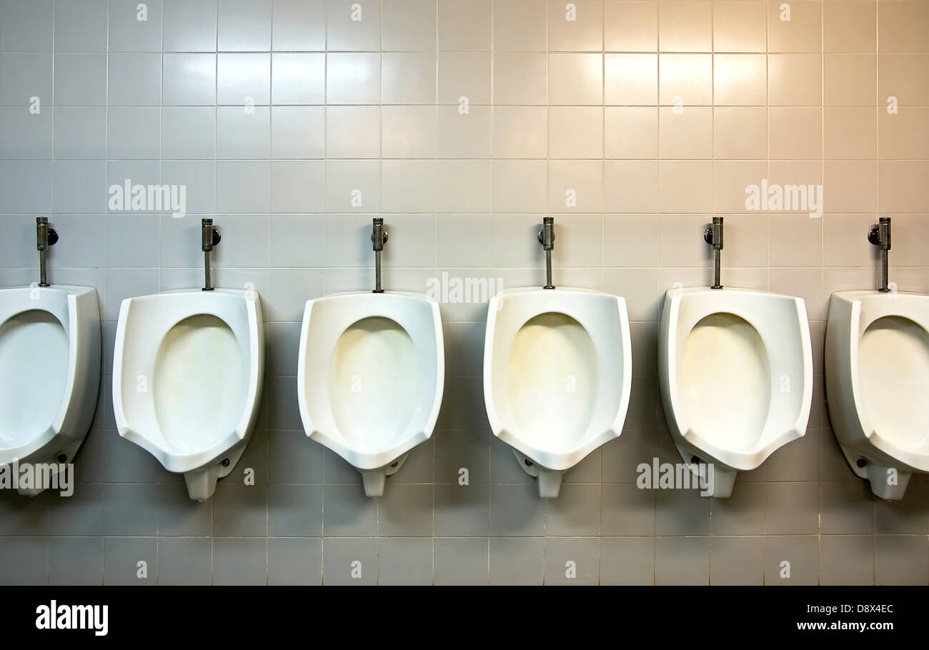 A row of urinals in tiled wall in a public restroom Stock Photo - Alamy