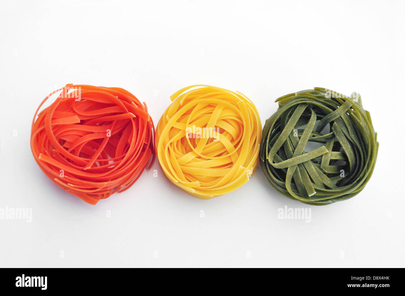 Three colored dry pasta nests Stock Photo - Alamy