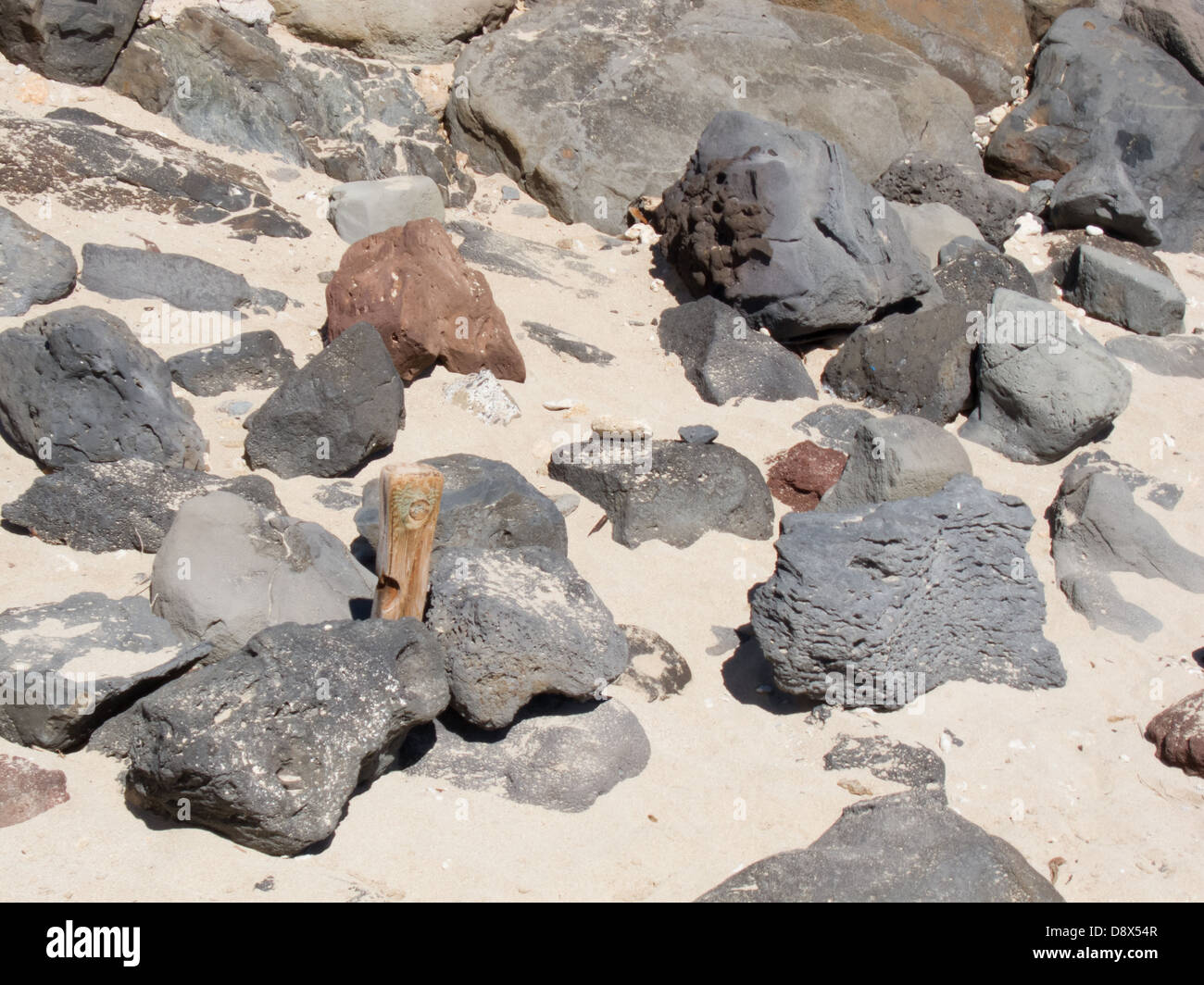 Lava rocks on the beach with sand Stock Photo - Alamy
