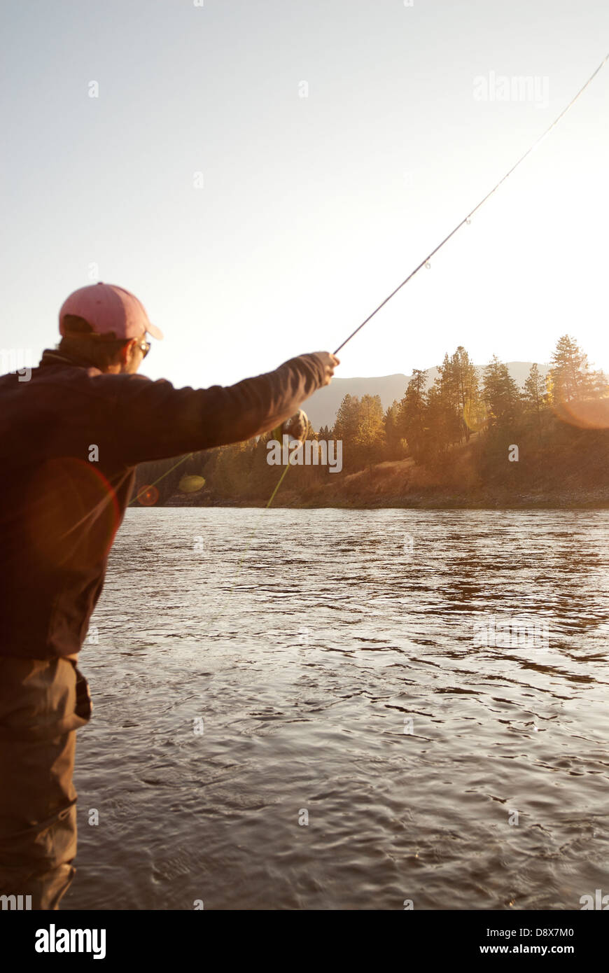 Man casting a fly rod while flyfishing in a river in Montana Stock ...