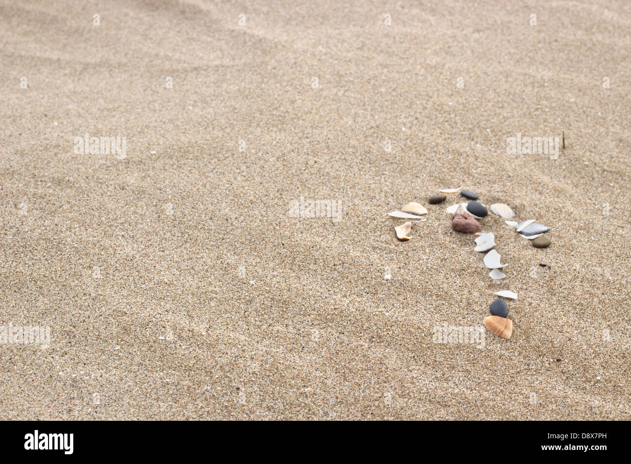 Arrow made on the beach with shells and stones Stock Photo - Alamy