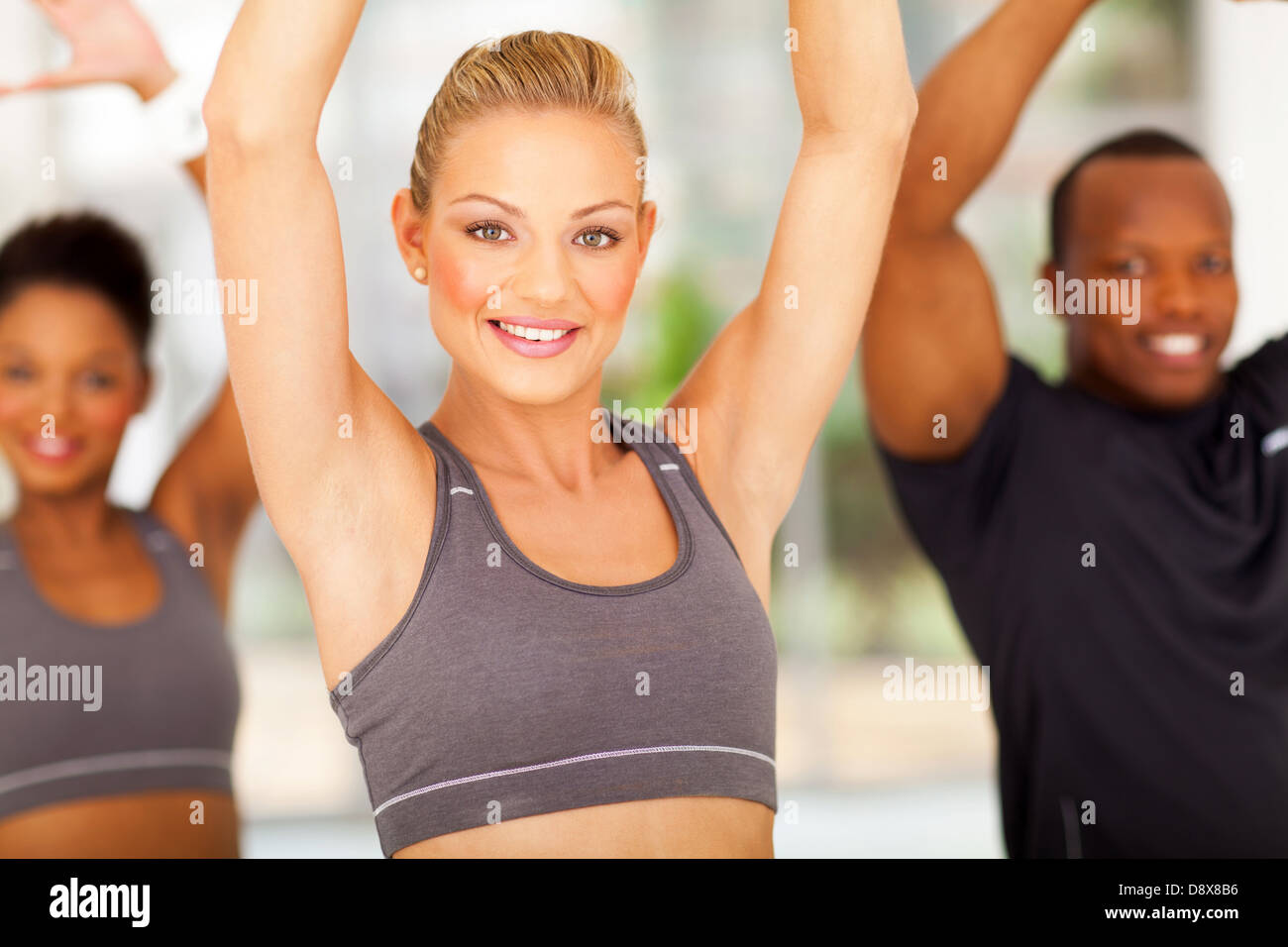 beautiful healthy woman exercising with friends on background Stock ...