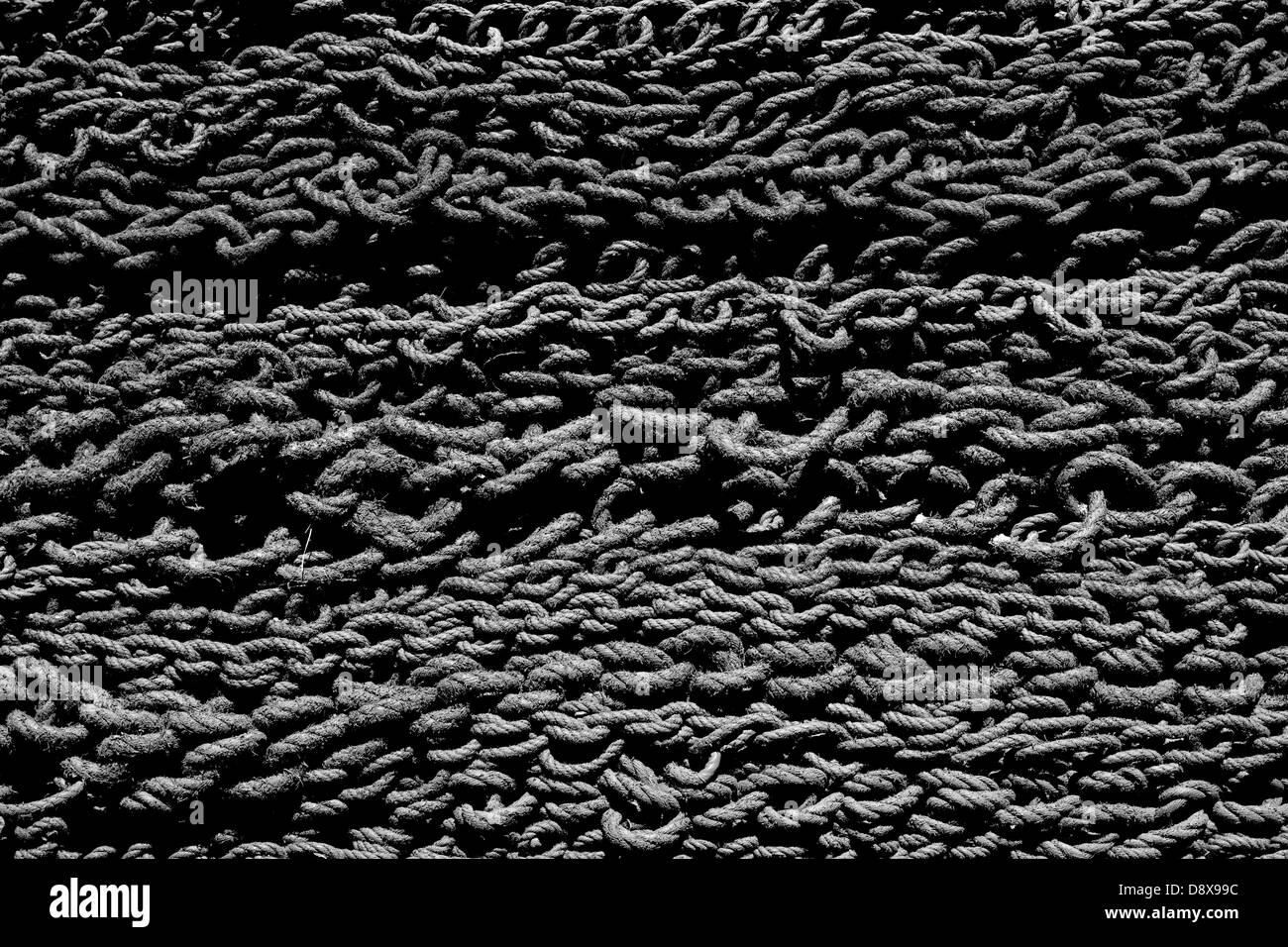 Tight stacks of rope forming a textured black and white background ...