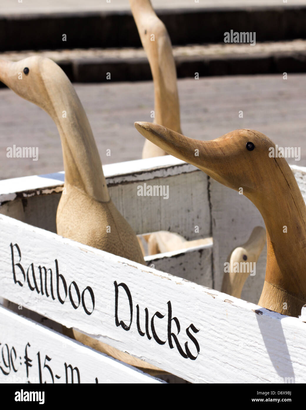 Bamboo ducks waiting patiently in the summer sunshine to be purchased ...