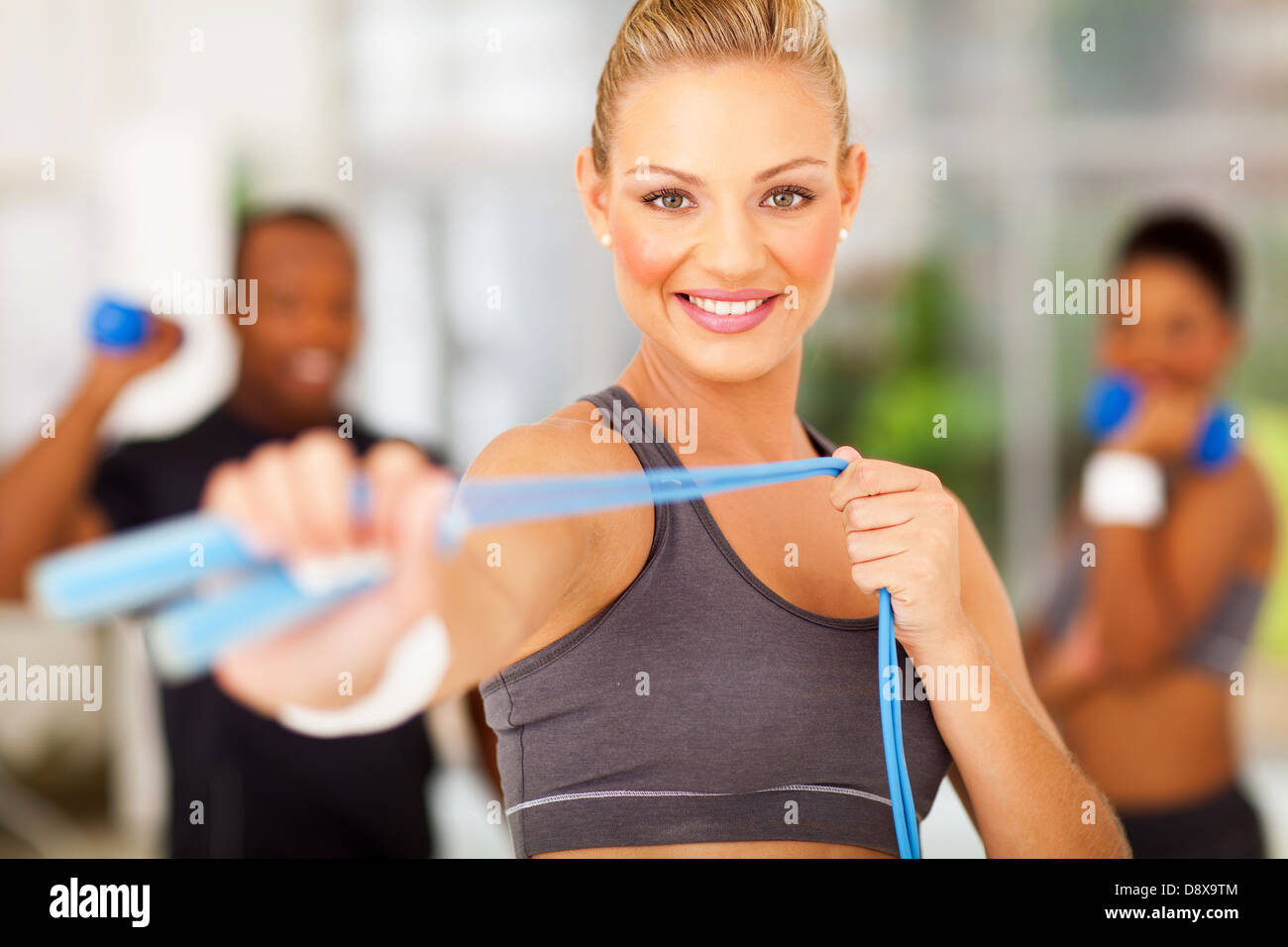 smiling woman exercise in gym with jumping rope Stock Photo - Alamy