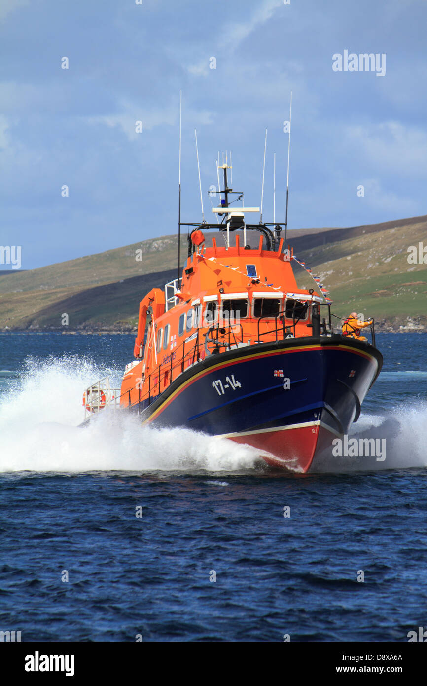 An RNLI lifeboat practises a rescue out at sea Stock Photo - Alamy