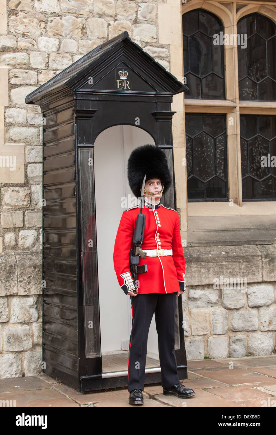 Welsh guard in ceremonial dress standing to attention on sentry duty ...