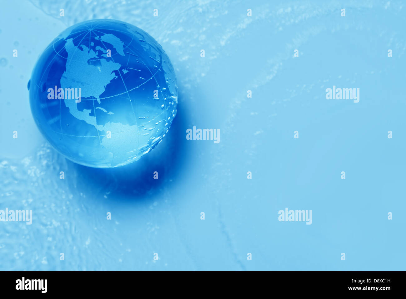 Glass globe in water Stock Photo - Alamy