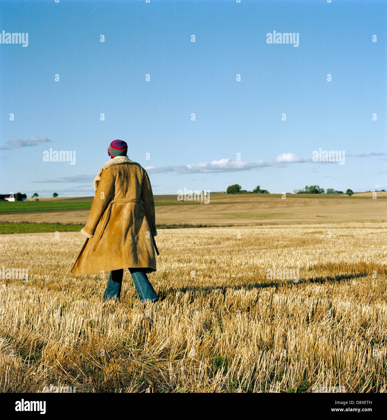 A Woman Walking in a Field Stock Photo - Alamy