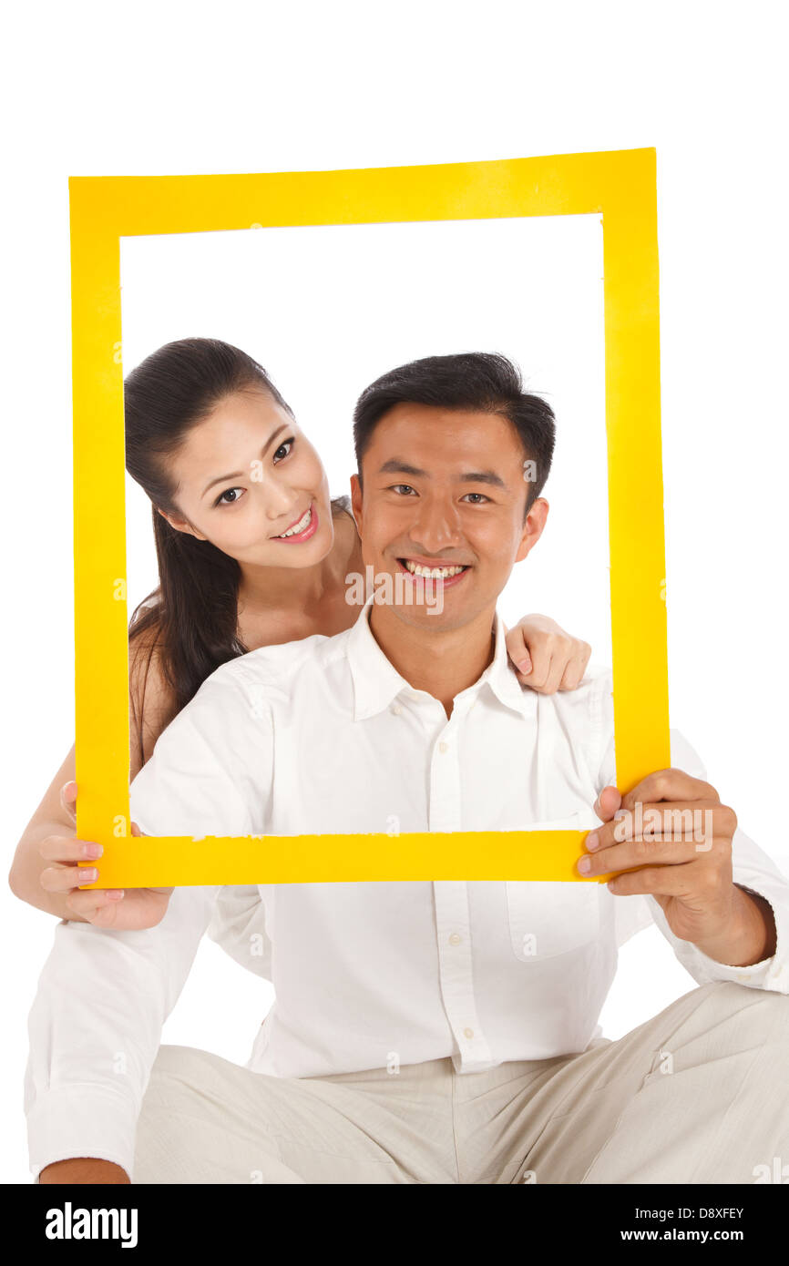 Young couple holding photo frame Stock Photo - Alamy