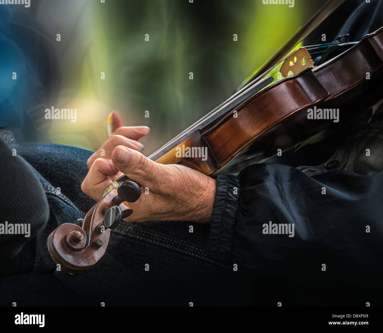 An editorial lifestyle image of a fiddle players hand Stock Photo - Alamy