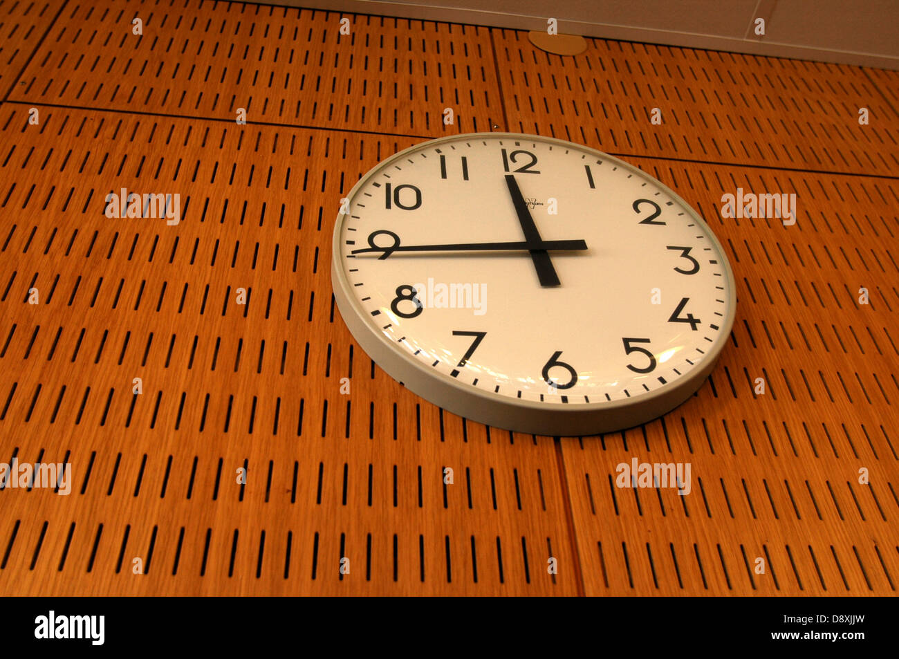 A clock on a wall in a school Stock Photo - Alamy