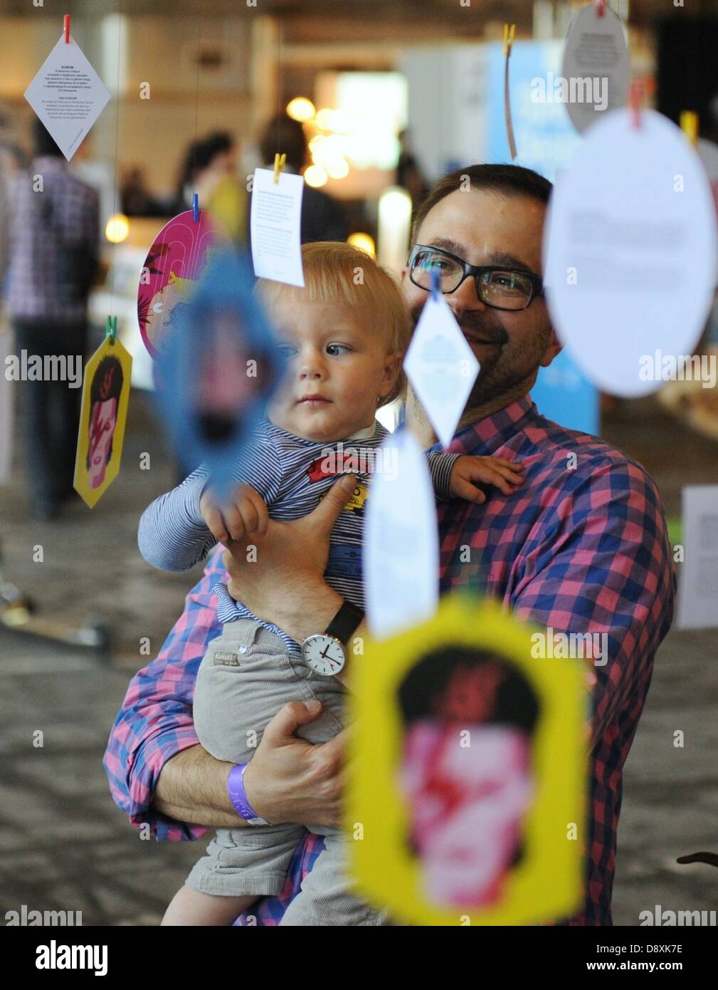 Little Antony sits on his father's arm, designer Jakub Szczesny, during ...