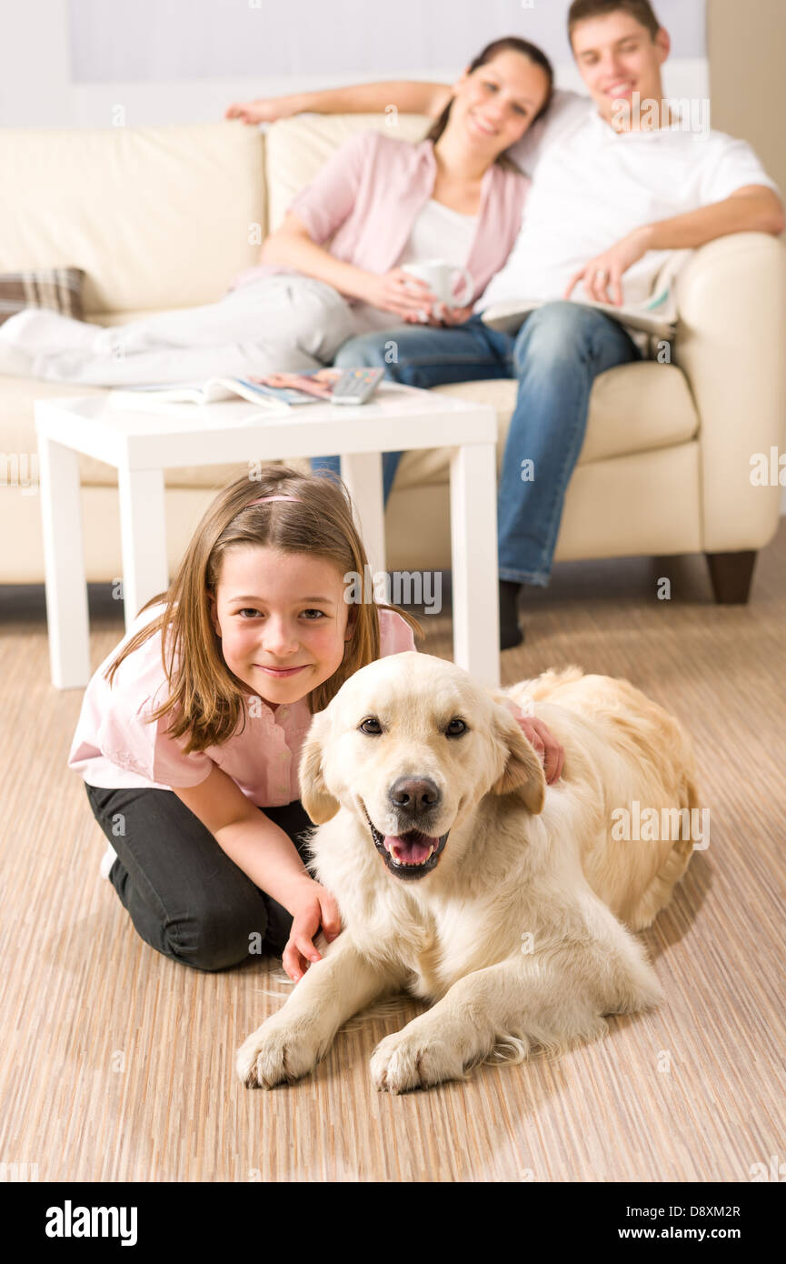 A happy family of three sitting with dog Stock Photo - Alamy