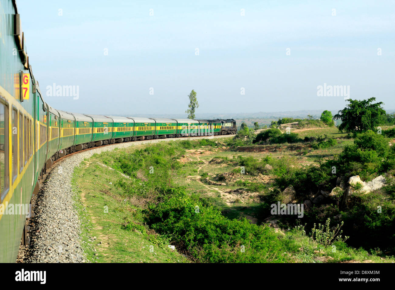An Indian railways' train (Garib rath) maneuvers a curve in the western ...