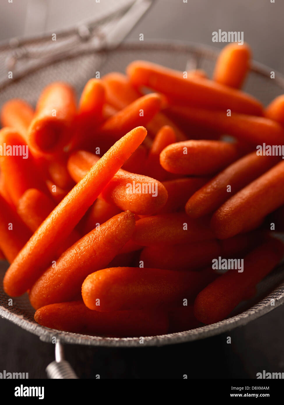 Young carrots in a metal sieve Stock Photo - Alamy