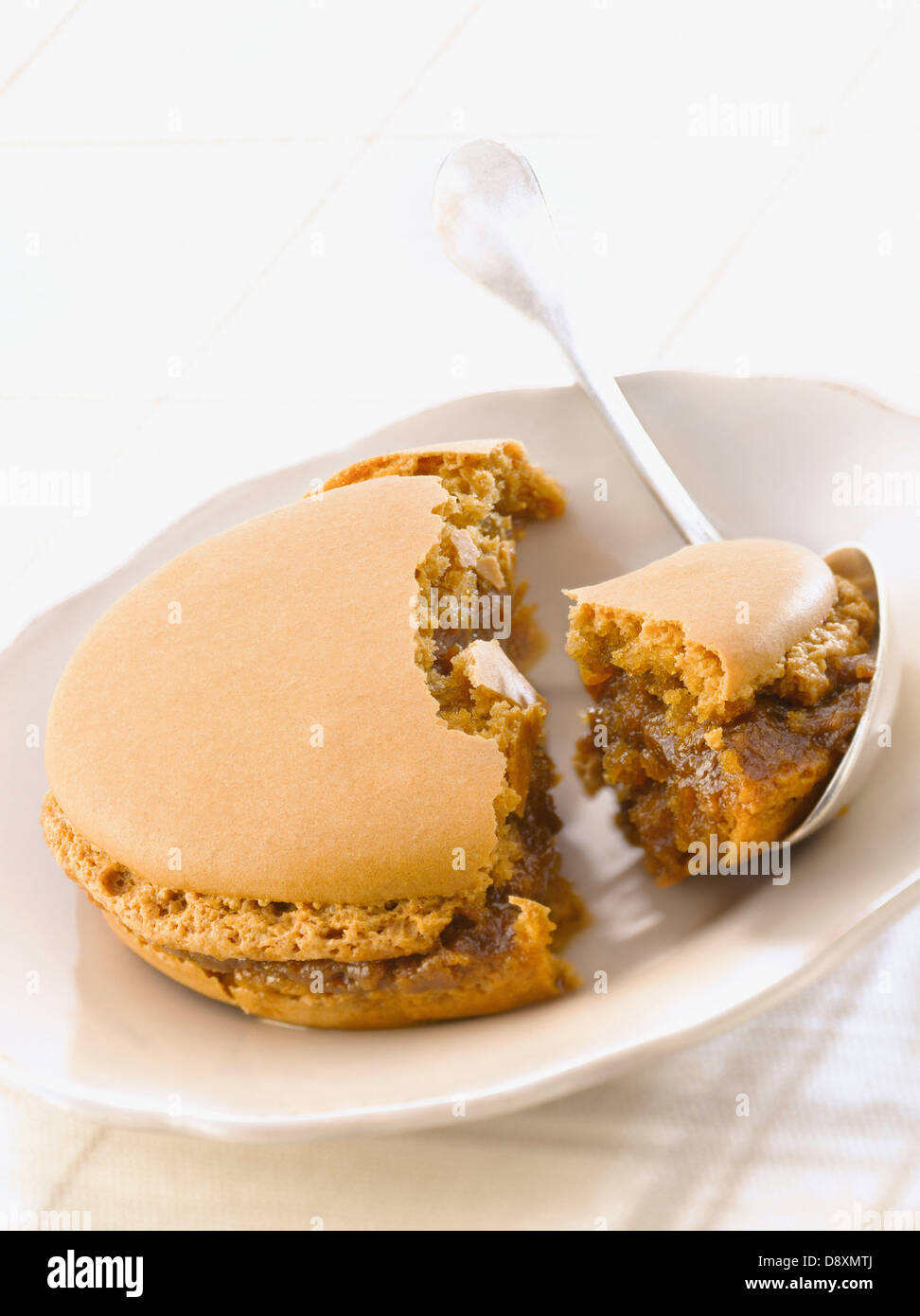 Eating a coffee macaroon Stock Photo - Alamy
