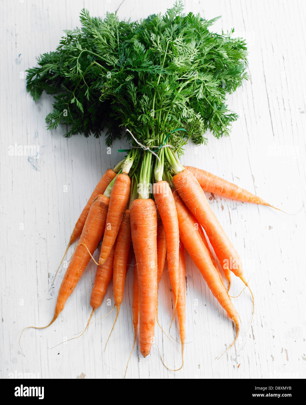 Bunch of carrots with their tops Stock Photo - Alamy