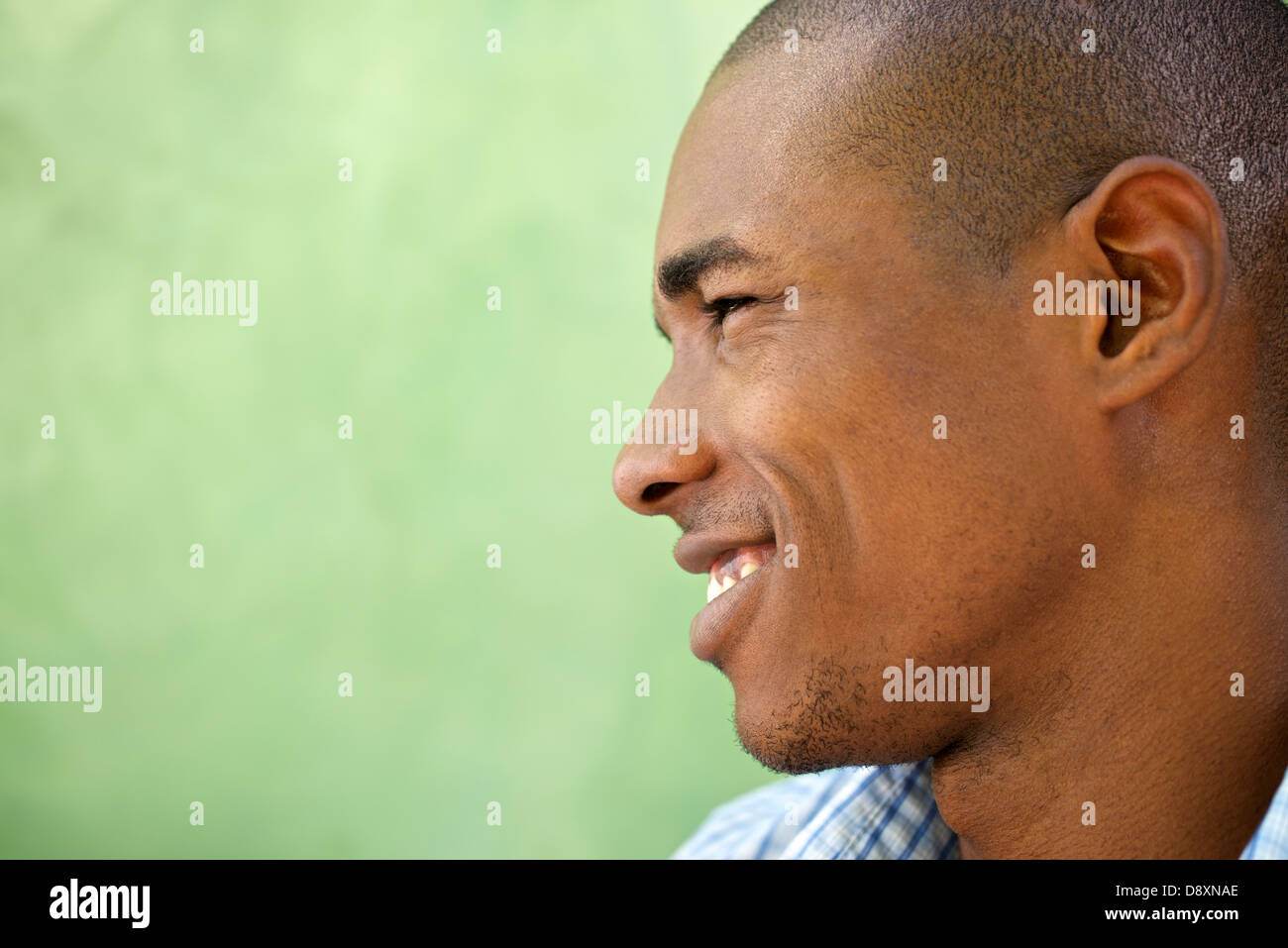 Portrait of happy young african american man looking away and smiling ...