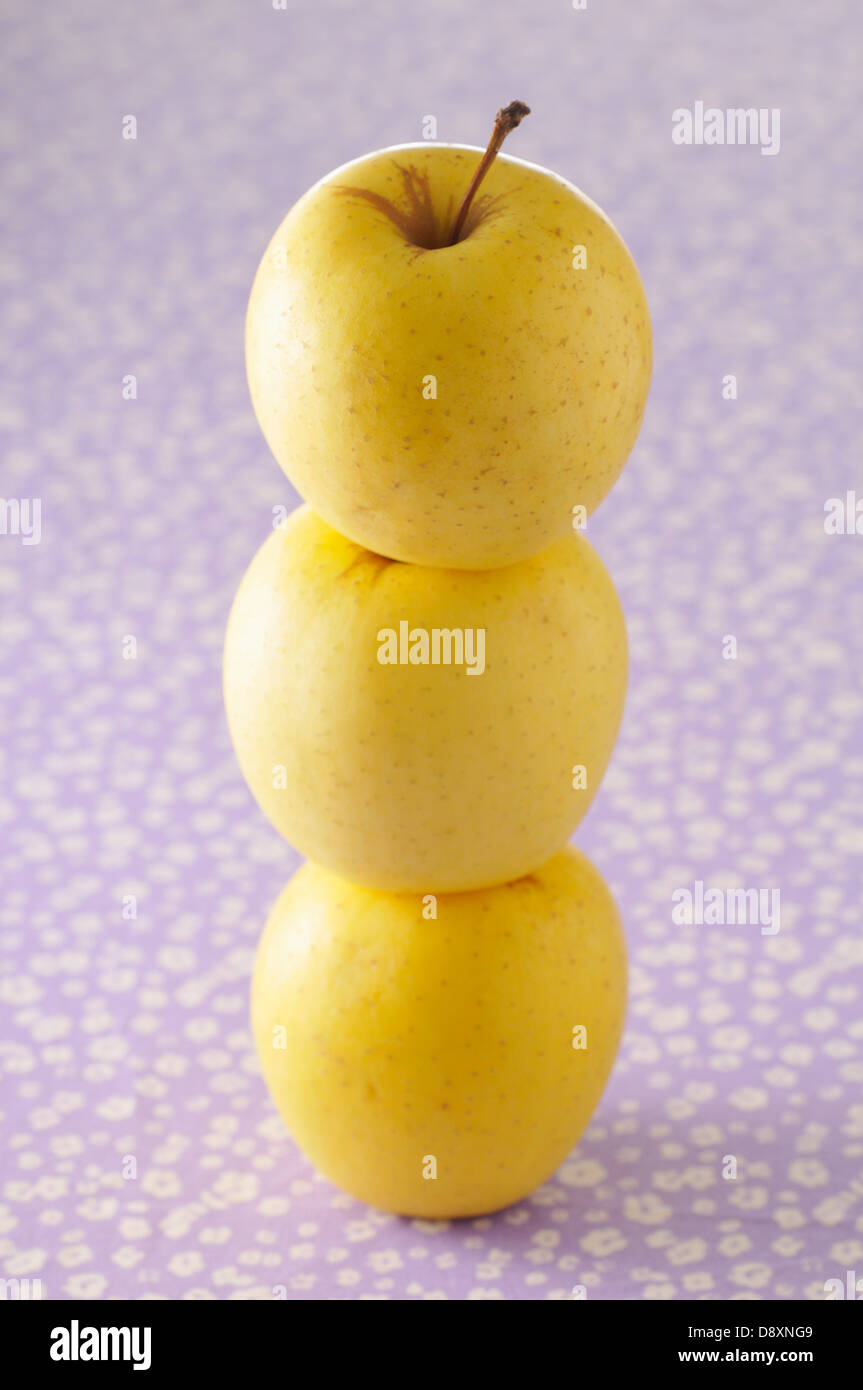Three stacked Golden apples Stock Photo - Alamy