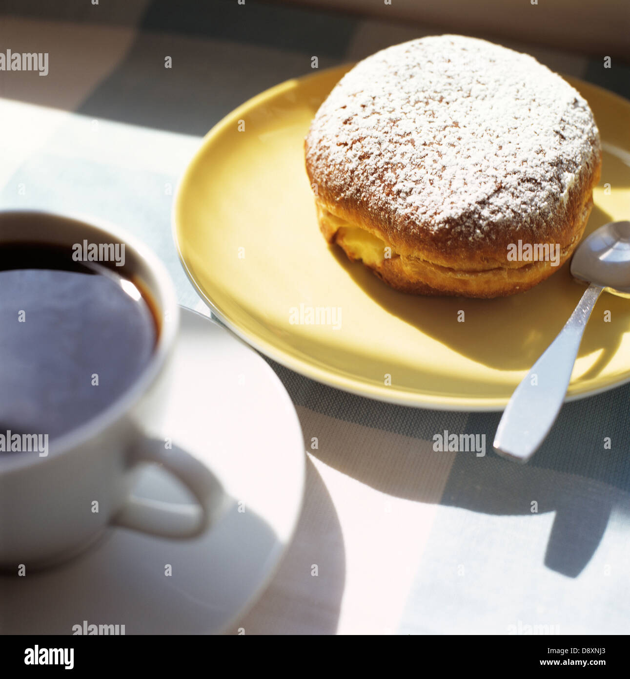 Coffee cup with plate of bun Stock Photo - Alamy