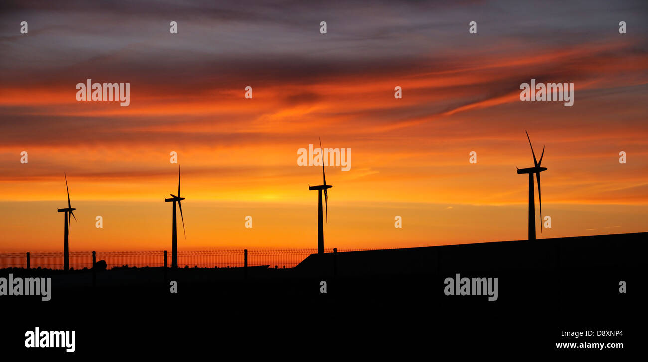 Four Wind Turbines against Sunset Stock Photo - Alamy