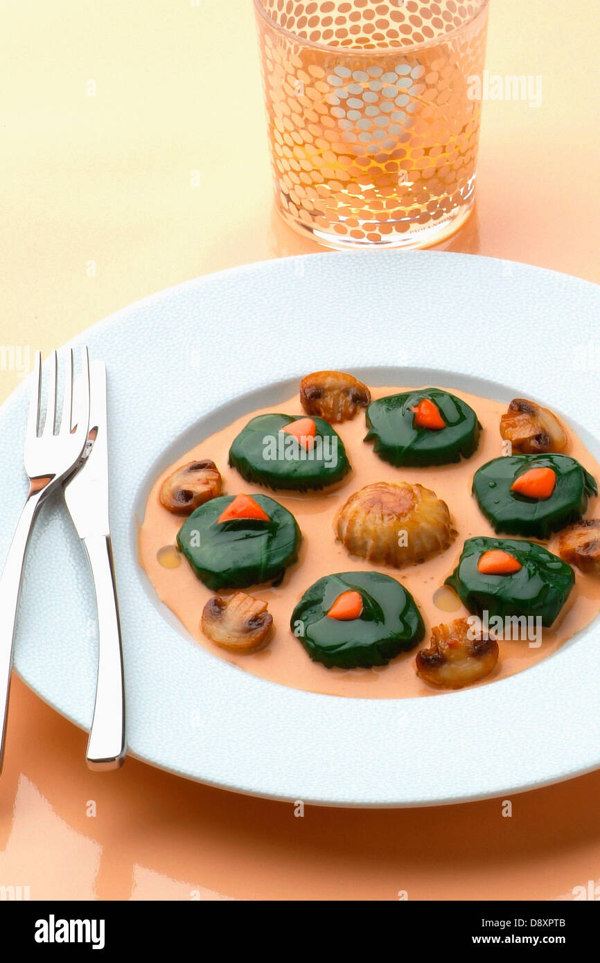 Scallops coated in green,mushrooms and scallop roe sauce Stock Photo ...