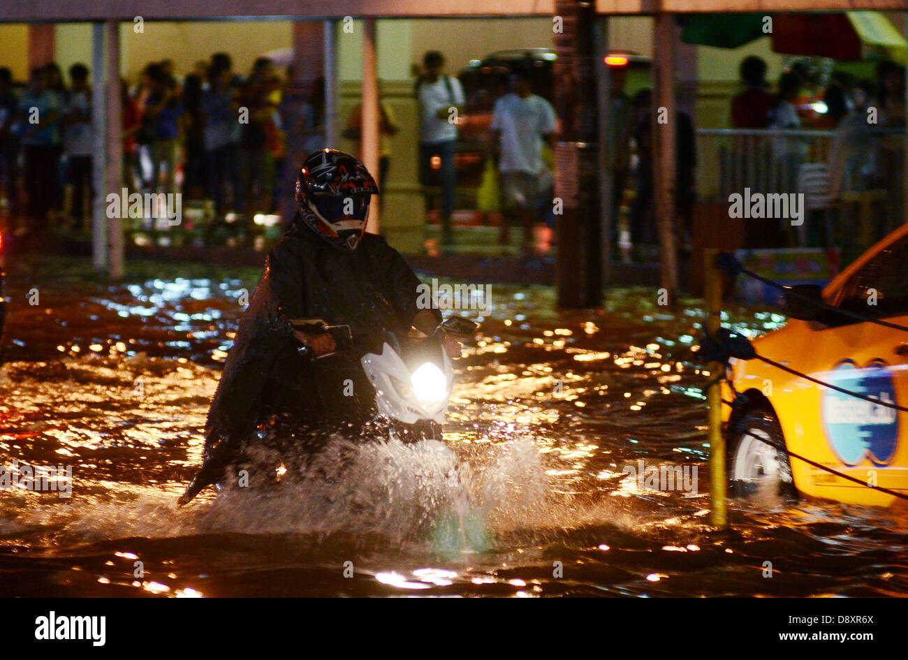 Davao, Philippines. 6th June 2013. Motorist pass on flood water cause ...