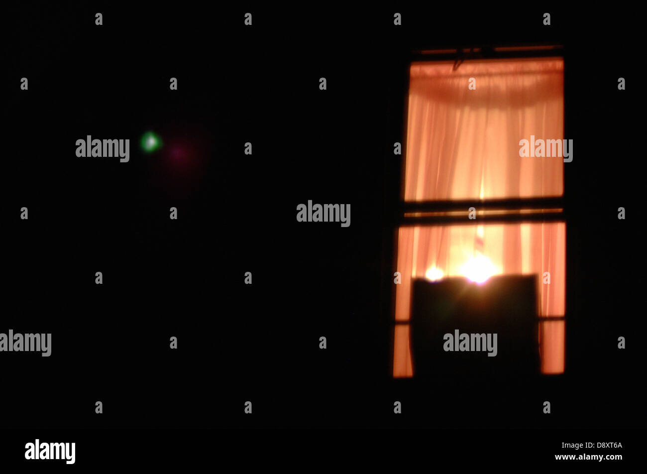A lightened window in the darkness Stock Photo - Alamy