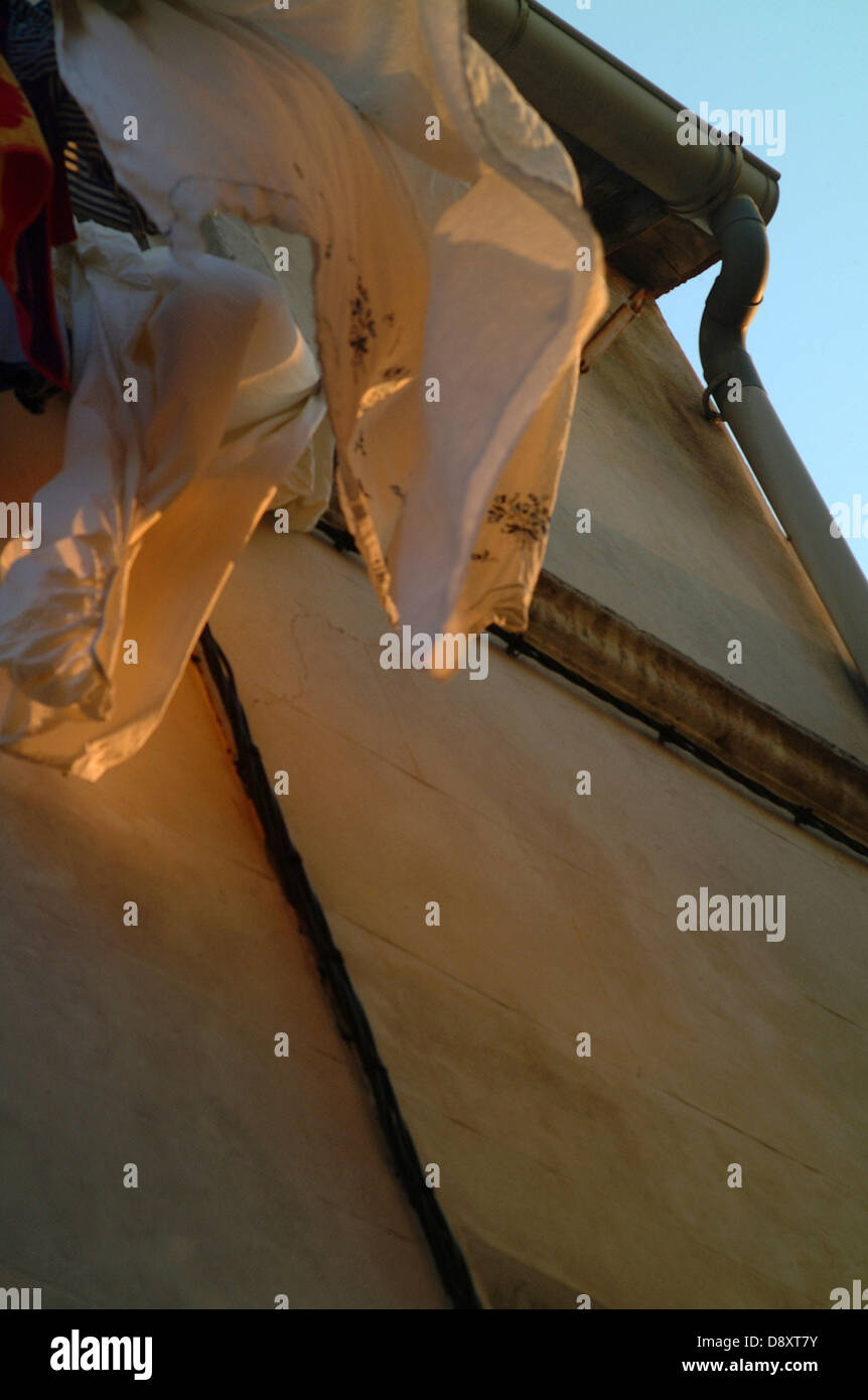 Sheets hanging from a window Stock Photo - Alamy