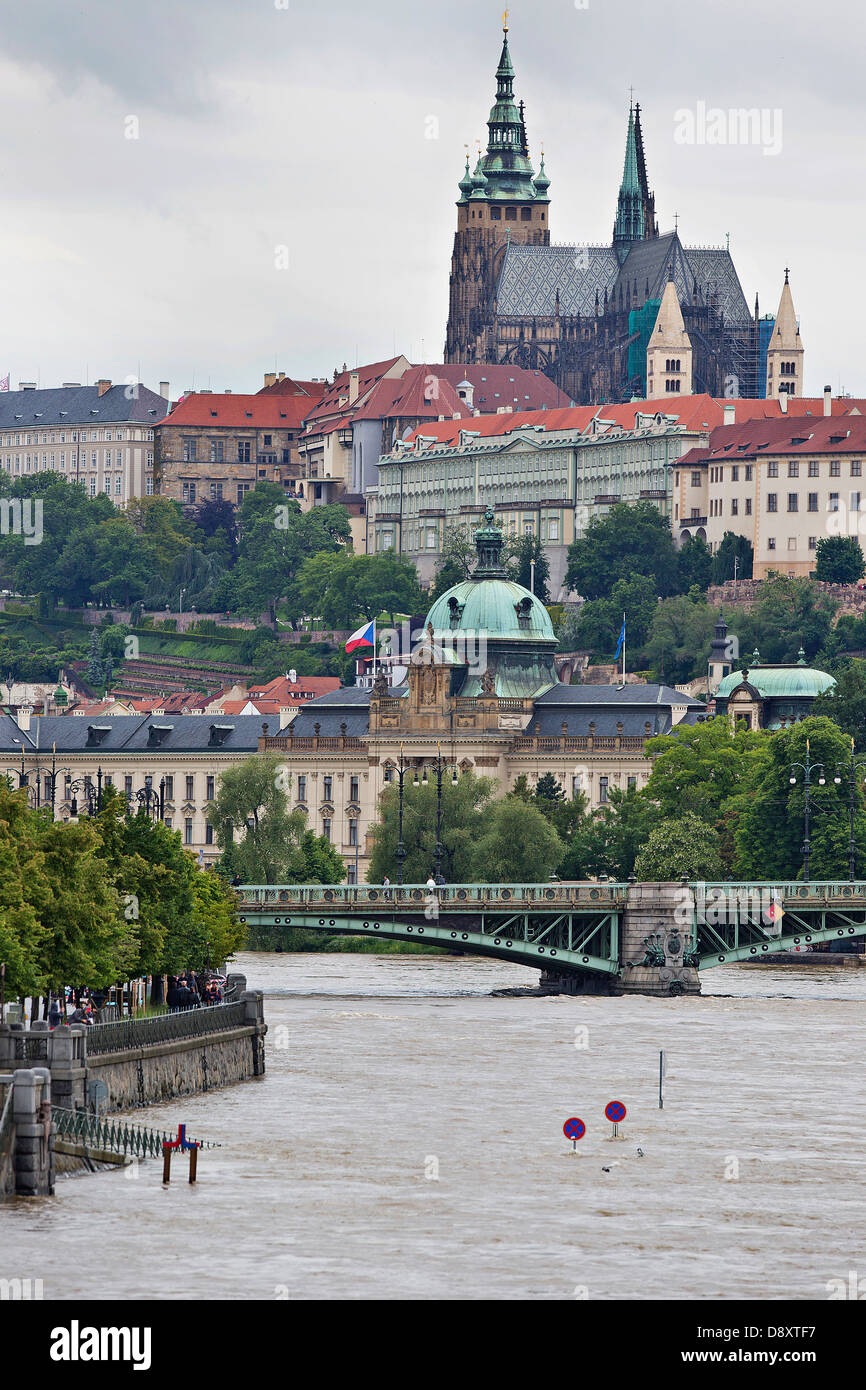 People cross Cech Bridge in center Prague as flooded Vltava river ...