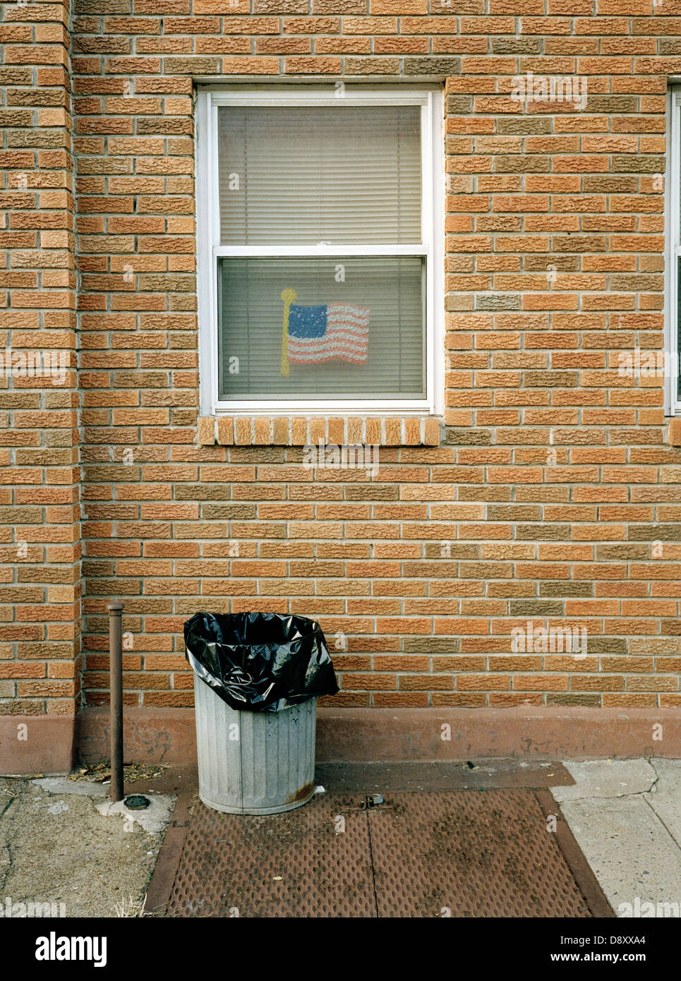 Garbage bin in front of brick wall Stock Photo - Alamy
