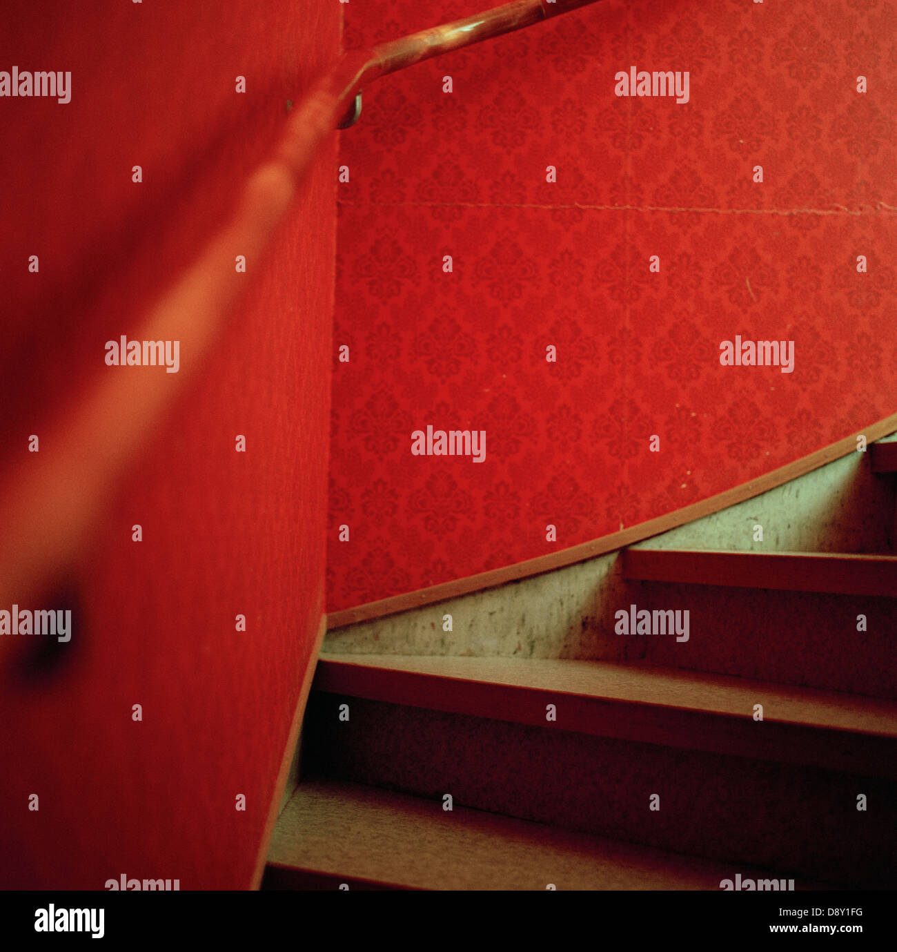 Detail of stairs and red wallpaper Stock Photo - Alamy