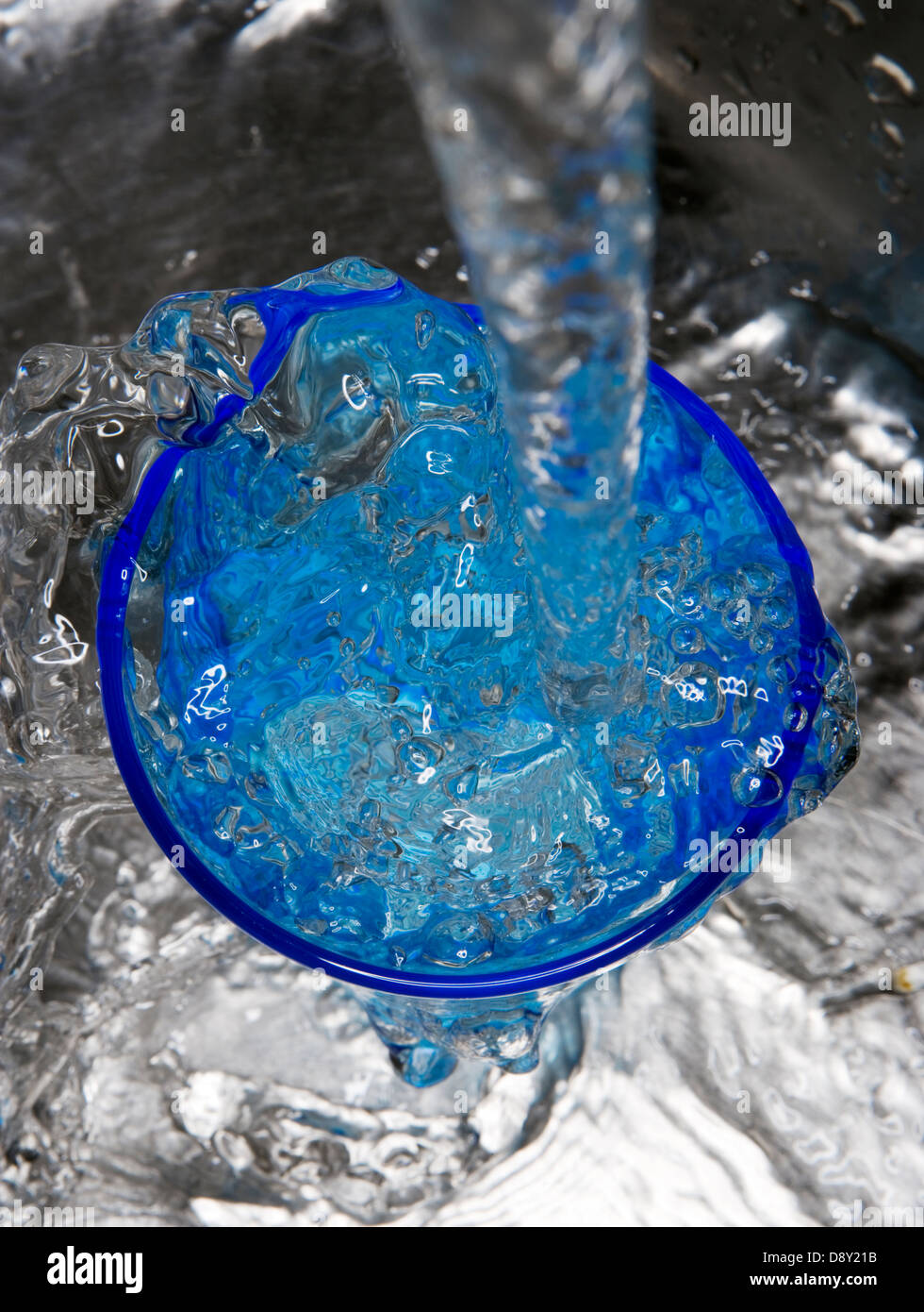 Running water and blue glass bowl Stock Photo - Alamy