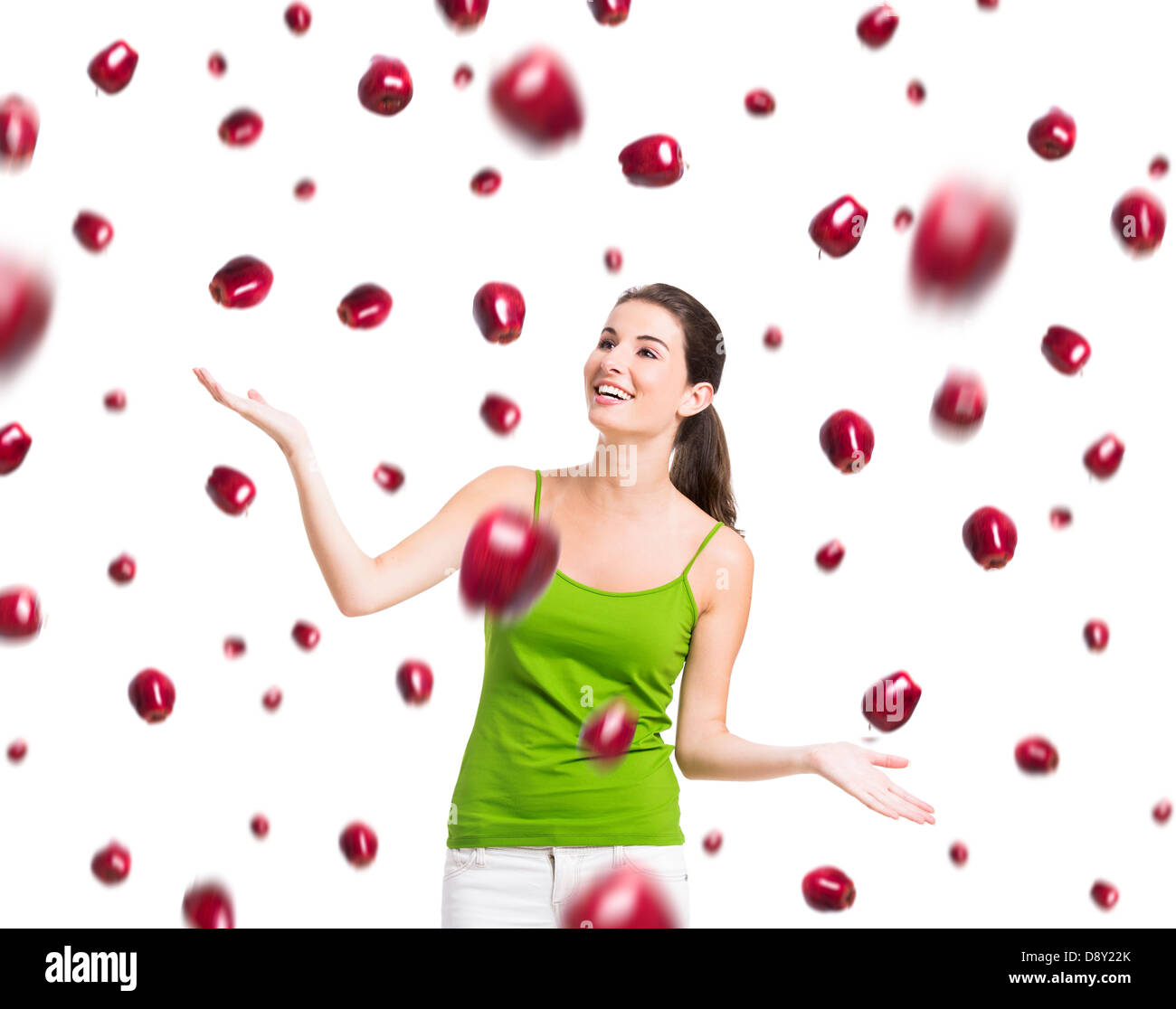 Healthy woman catching apples falling from the sky, isolated over a ...