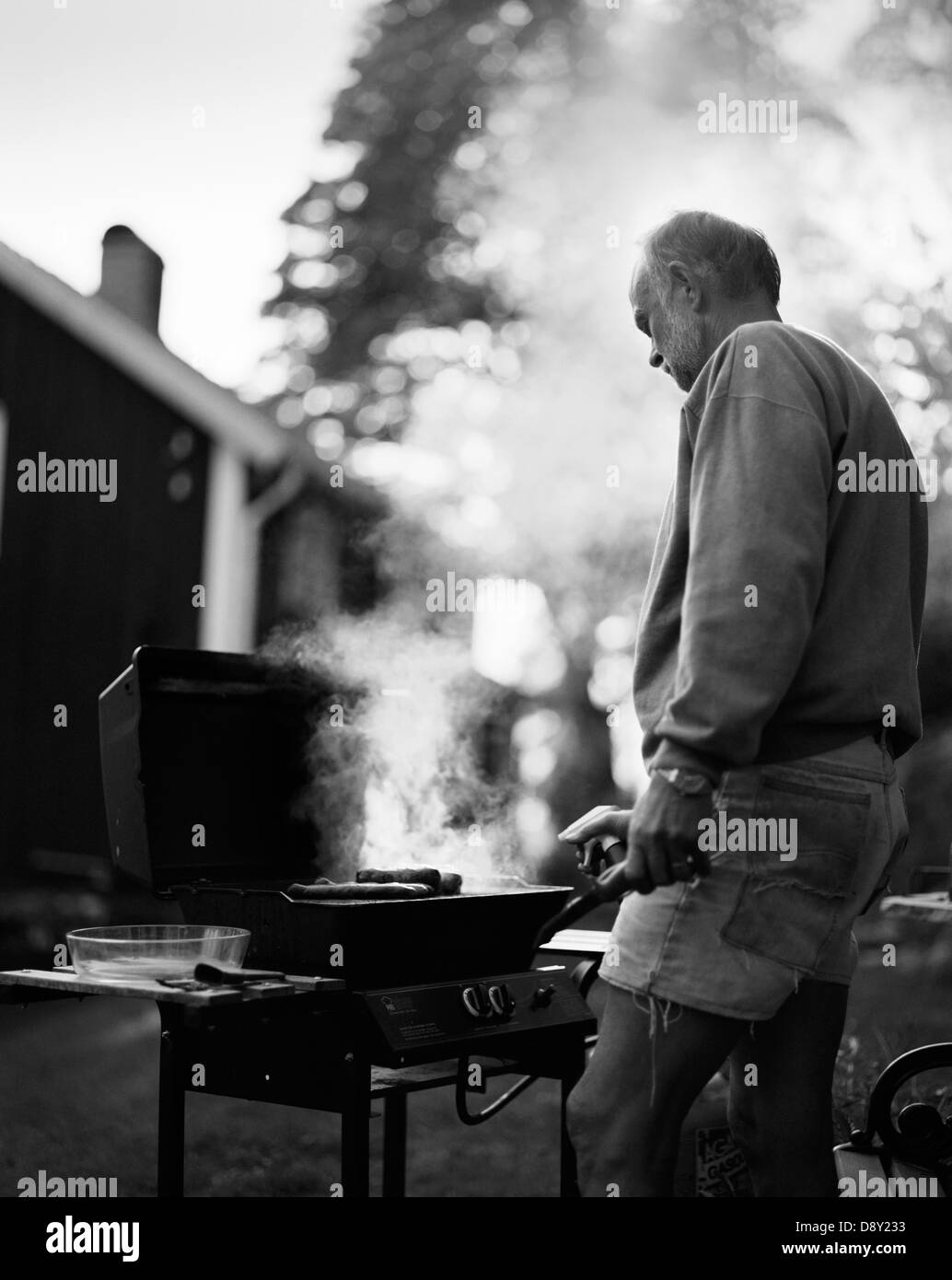Mature man cooking food Black and White Stock Photos & Images - Alamy
