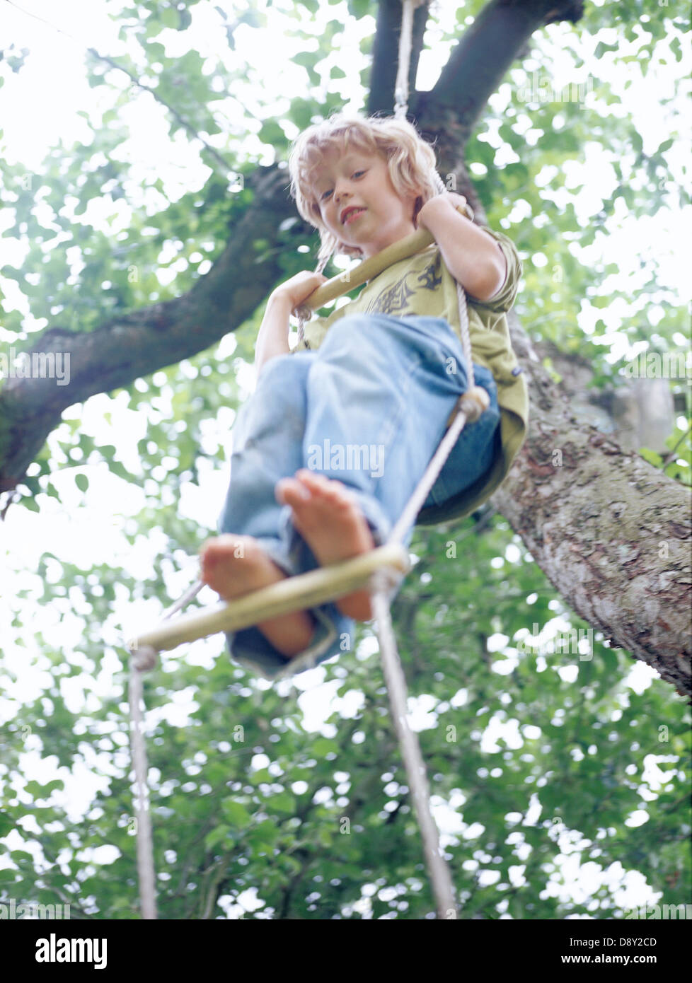 Boy climbing tree barefoot hi-res stock photography and images - Alamy