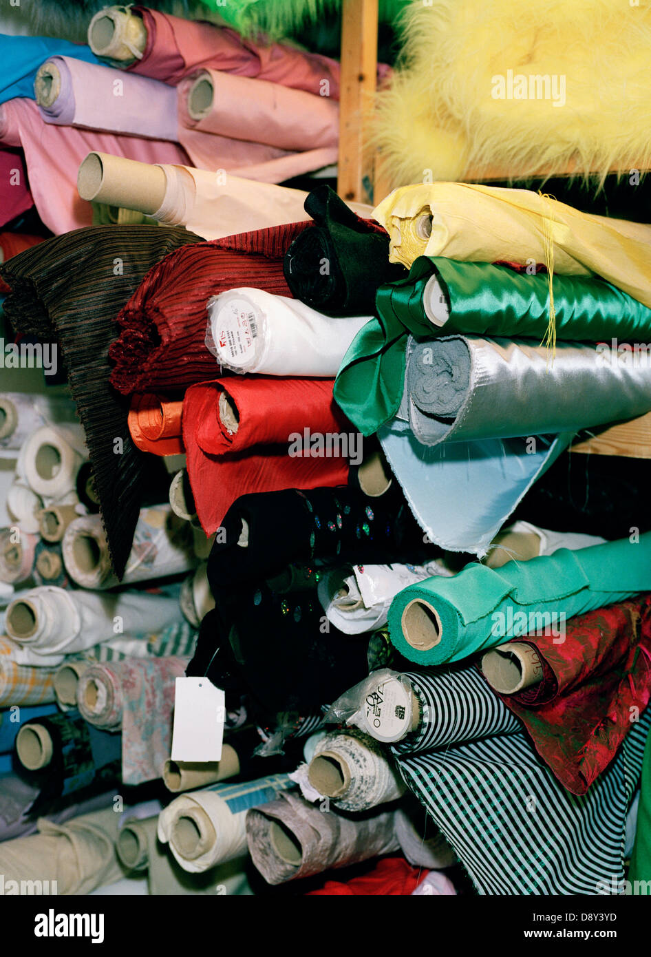 Rolled up multicolored cloth pieces in rows, close-up Stock Photo - Alamy