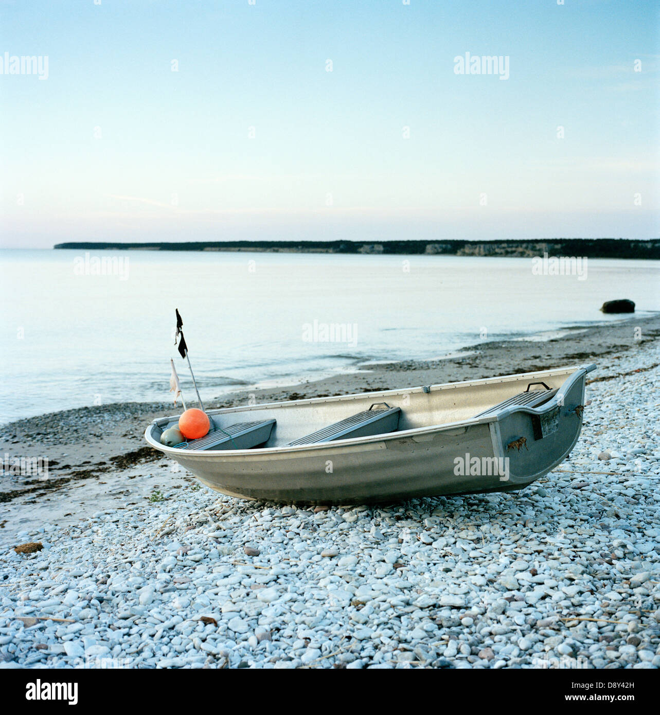 A boat on a pebble beach Stock Photo - Alamy