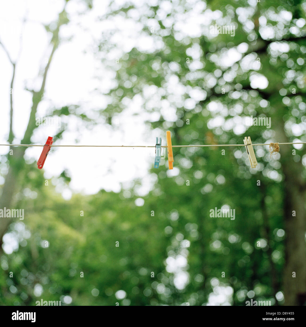 Clothes pegs on a clothesline Stock Photo - Alamy